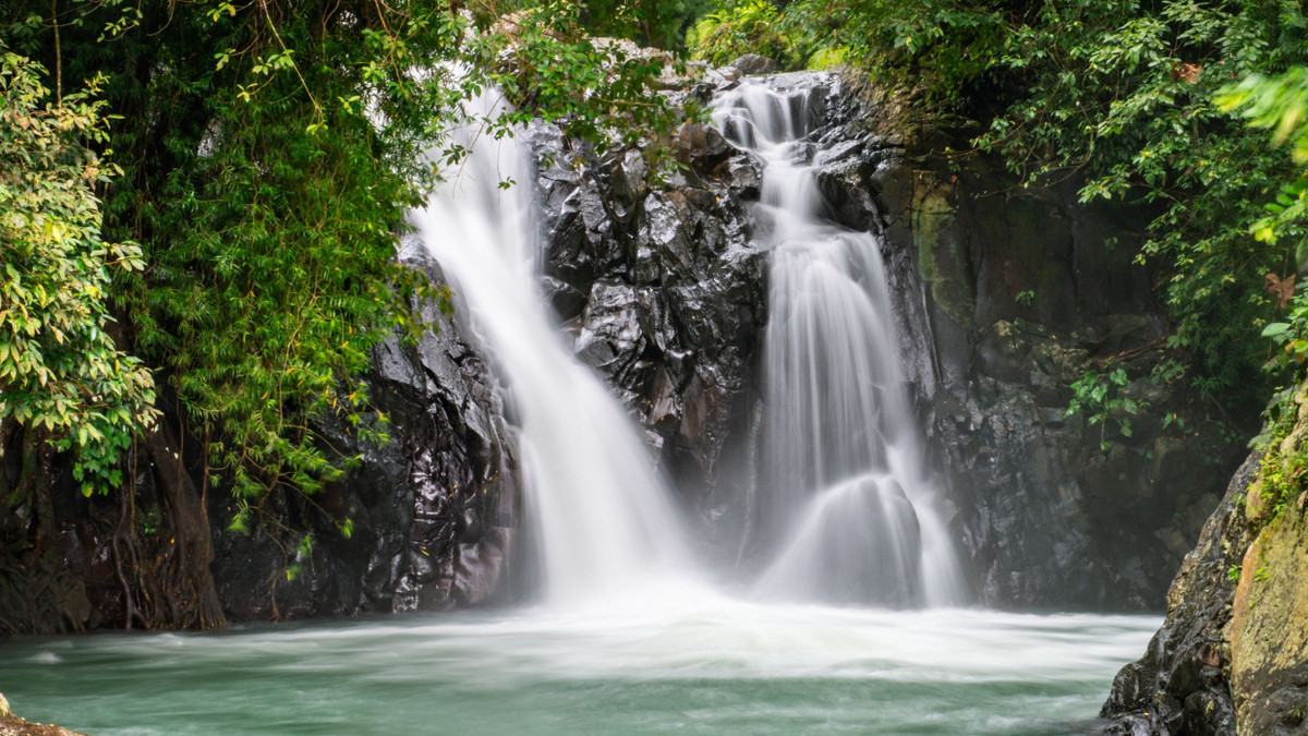 These Secret Bali Waterfalls Boast A Natural Slide & Are Instagram-Perfect